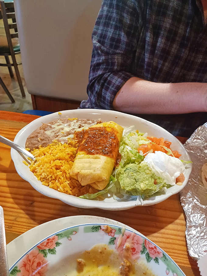 The perfect bite awaits: crispy tortilla giving way to savory filling, with that red sauce adding just enough kick to wake up your taste buds. 