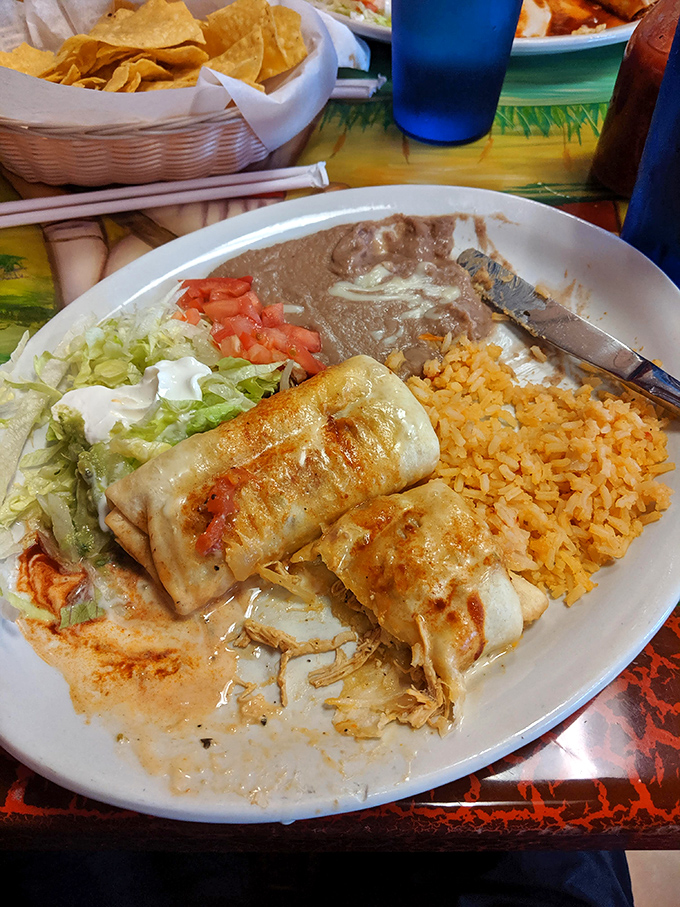 A chimichanga that's achieved the impossible dream: crispy exterior, tender interior, and enough toppings to make a salad bar jealous.