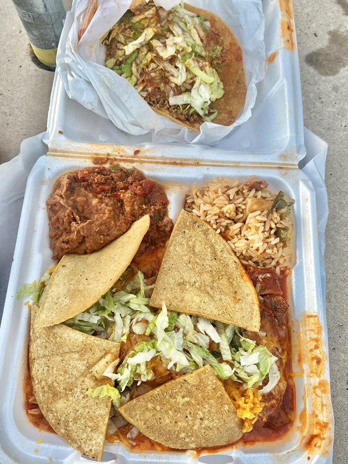 Behold the holy trinity of New Mexican comfort: crispy corn tortillas, vibrant red chile, and beans that didn't come from any can. Pure edible geometry.