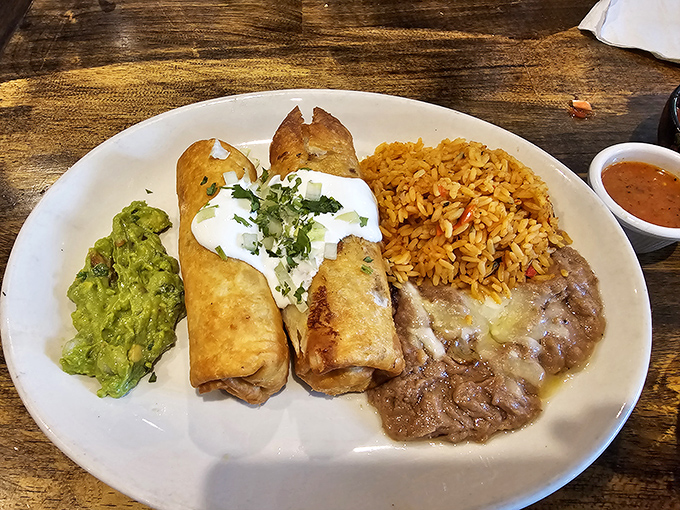 The chimichanga trinity: crispy tortilla, hearty filling, and sides that don't know the meaning of "afterthought." This plate means business.