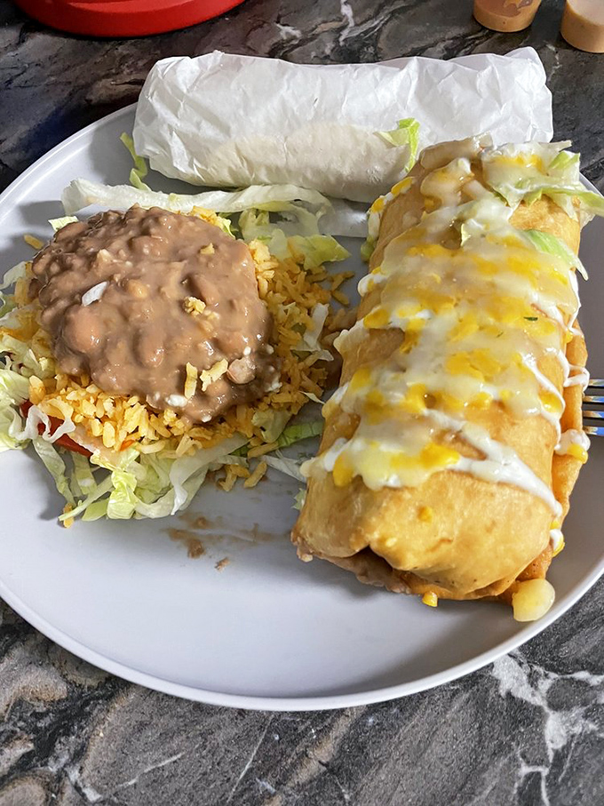 If Michelangelo sculpted Mexican food, it might look like this chimichanga &ndash; perfectly golden, draped in cheese, with rice playing a supporting role worthy of an Oscar.