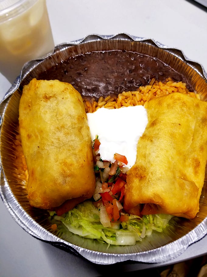 Golden-fried perfection nestled beside vibrant rice and beans&mdash;this chimichanga to-go container might not make it home.