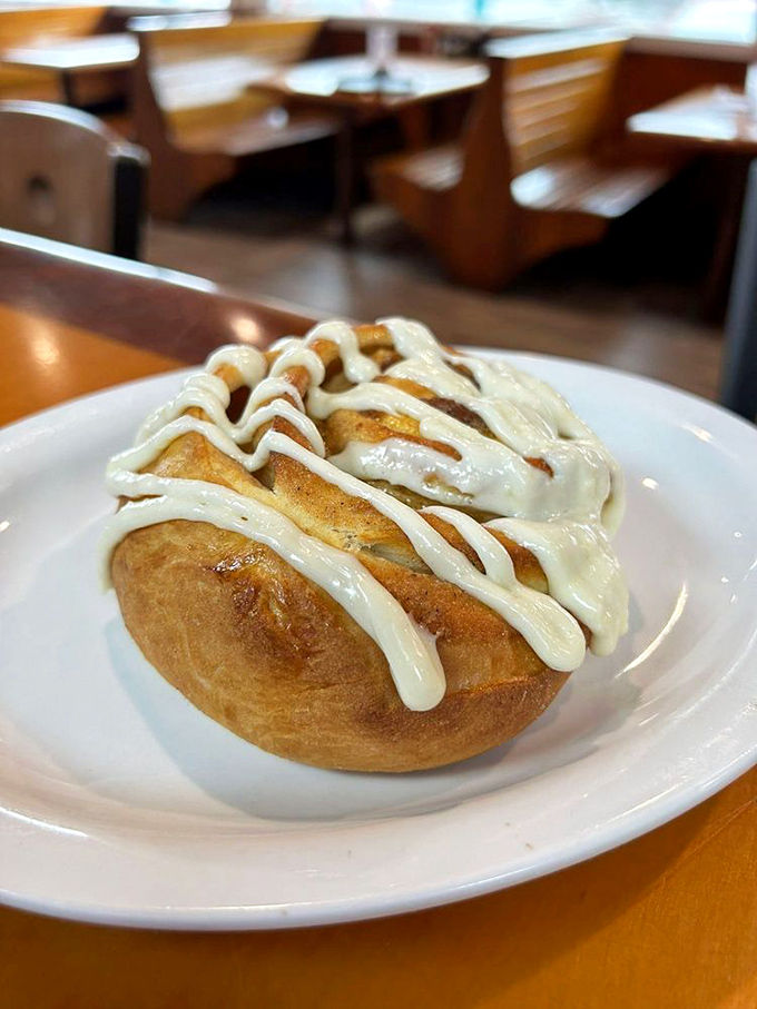 This isn't just a cinnamon roll&mdash;it's edible architecture. The cream cheese drizzle creates rivers of sweetness through valleys of cinnamon-spiced dough.