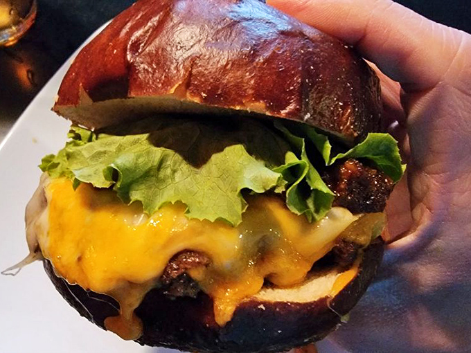 Melted cheese cascades down this burger like a golden waterfall of deliciousness. The pretzel bun is the unsung hero of this rock ballad.