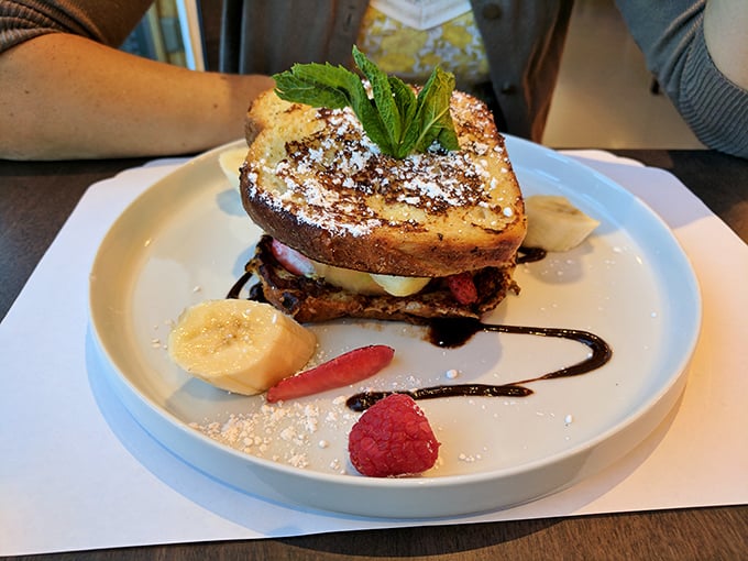The coconut French toast arrives like a tropical vacation on a plate, with fruit so fresh it might have been picked while you were ordering.