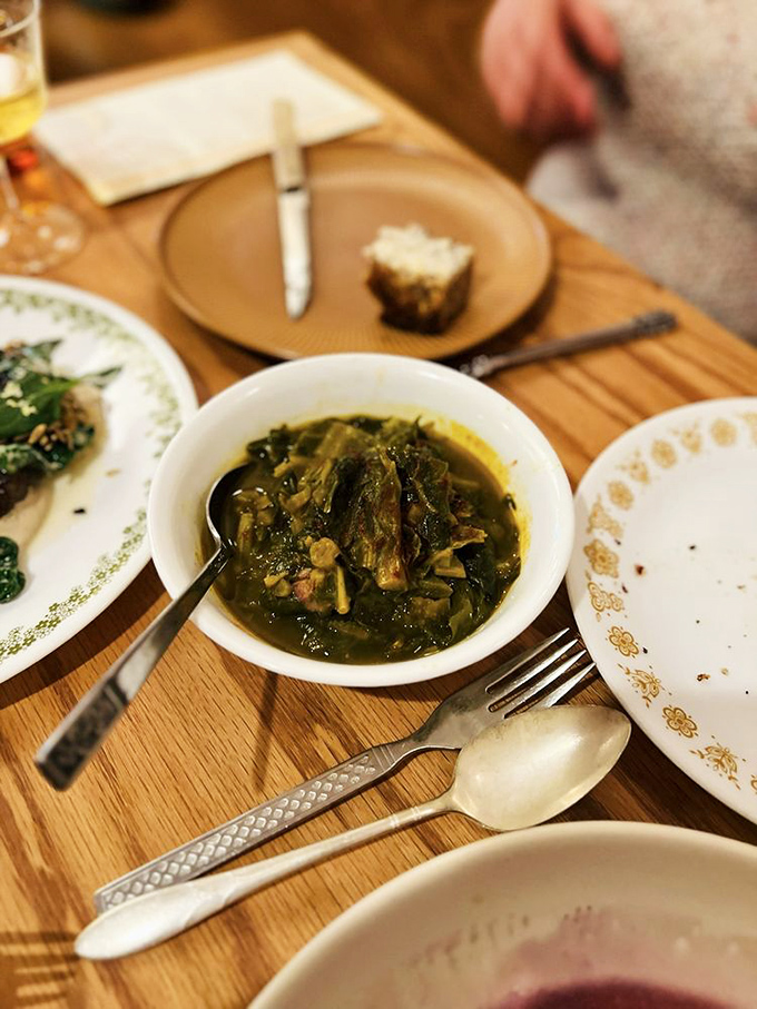 These collard greens aren't just cooked; they're coaxed into telling their life story, swimming in a broth you'll want to bottle and take home.