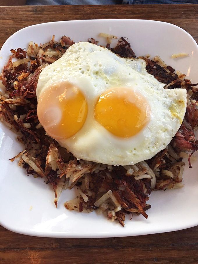 The holy trinity of breakfast perfection: crispy hash browns, tender corned beef, and eggs with yolks like liquid sunshine.