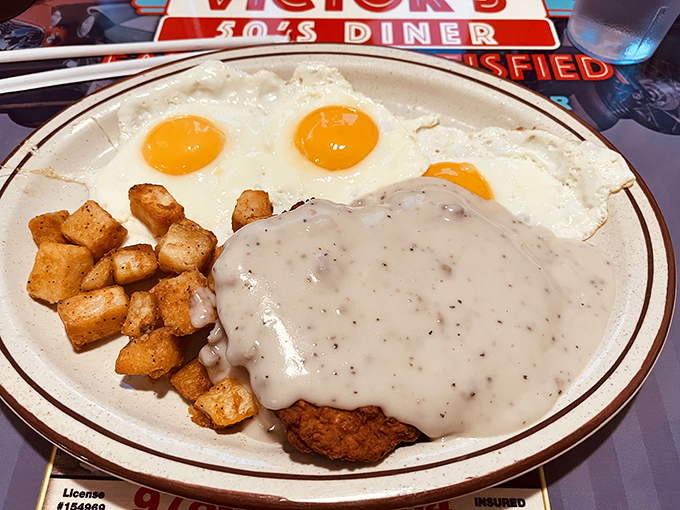 Breakfast of champions: three sunny-side-up eggs keeping watch over golden home fries and that legendary country fried steak blanketed in peppery gravy. 