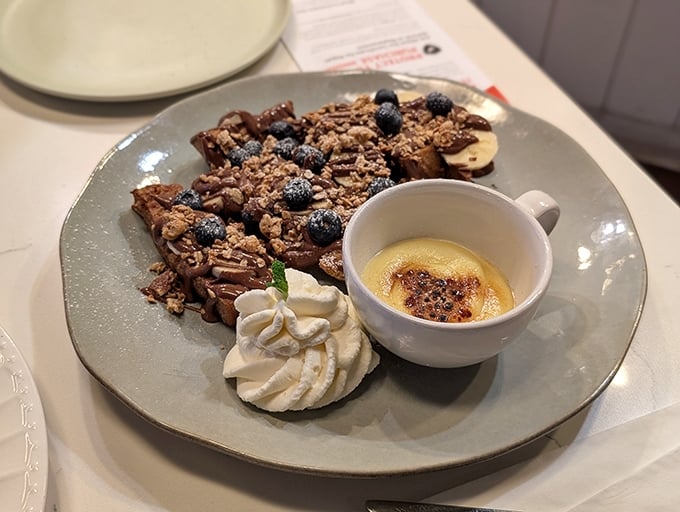 The Custard Cr&egrave;me Br&ucirc;l&eacute;e French Toast arrives like breakfast royalty&mdash;crispy exterior, custardy interior, and that br&ucirc;l&eacute;ed topping that demands to be cracked.