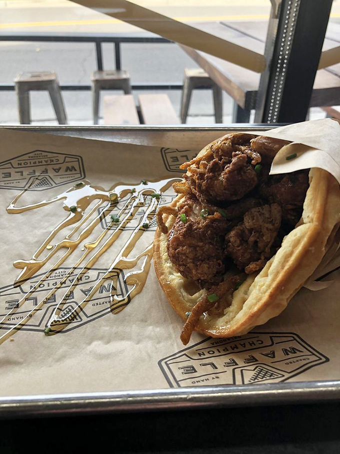 Architecture of deliciousness: crispy chicken, golden waffle, and that honey drizzle creating the perfect sticky-sweet symphony.