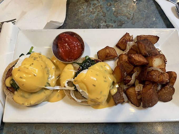 Eggs Benedict: where hollandaise sauce flows like liquid gold over perfectly poached eggs. Those home fries aren't just a side&mdash;they're co-stars.