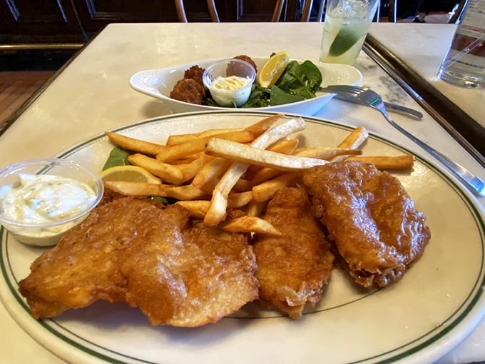 The holy trinity of comfort: crispy fish, golden fries, and those little crab balls that make you wonder why you'd eat anything else.