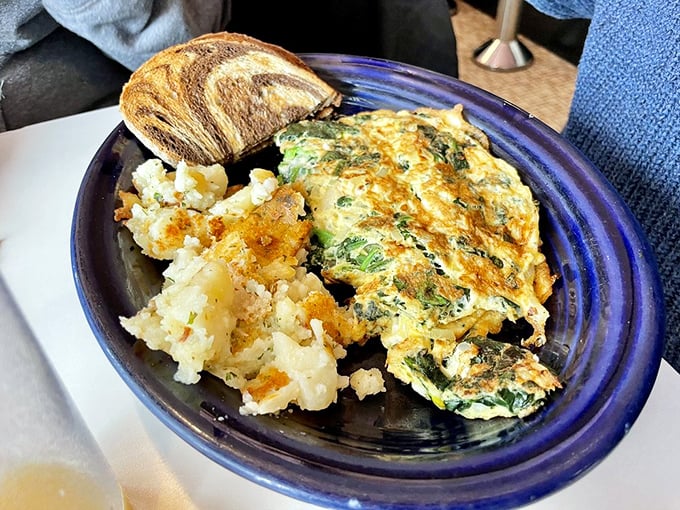 A spinach omelet that Popeye would approve of, paired with home fries that achieve that mythical crispy-outside, fluffy-inside perfection. 
