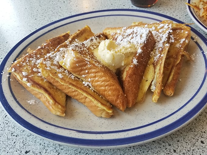 The French toast at Candy's isn't just breakfast &ndash; it's an event. Golden, crispy edges giving way to custardy centers under a snow of powdered sugar.