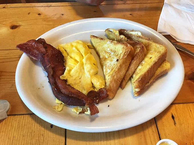 The breakfast trinity: perfectly scrambled eggs, bacon with just the right crisp-to-chew ratio, and toast that makes you wonder why anyone bothered inventing croissants.