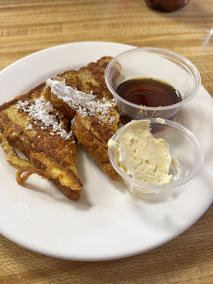 French toast that makes you question why you ever attempted to make it at home. That dusting of powdered sugar? Chef's kiss.