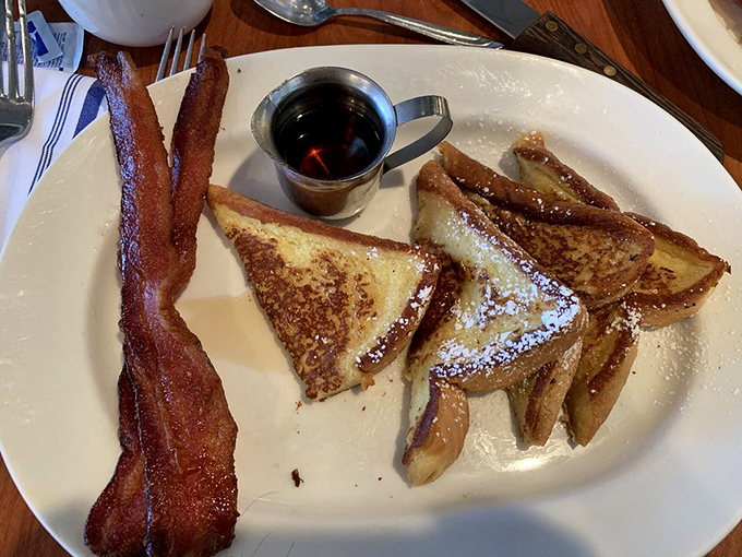 The age-old breakfast dilemma solved: crispy bacon alongside custardy French toast triangles. Whoever said you can't have it all clearly never ate here.