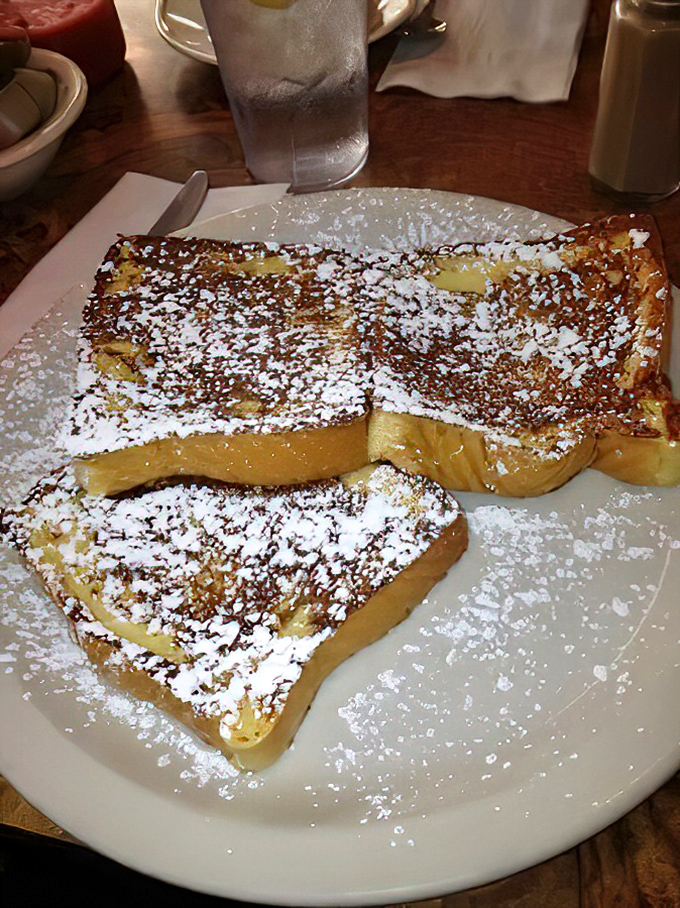 Golden-brown French toast dusted with powdered sugar&mdash;proof that sometimes the simplest pleasures are the most satisfying morning companions.