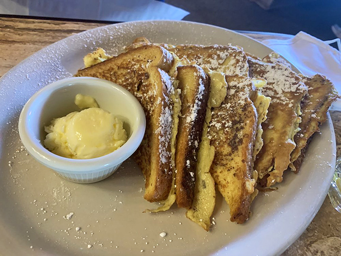 French toast that puts ordinary bread to shame&mdash;thick-cut, golden-brown, and dusted with powdered sugar. Butter melting into every crevice.