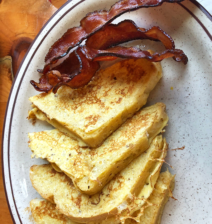 The breakfast equivalent of a perfect marriage. Crispy bacon and golden French toast sharing a plate in harmony that would make relationship counselors jealous.