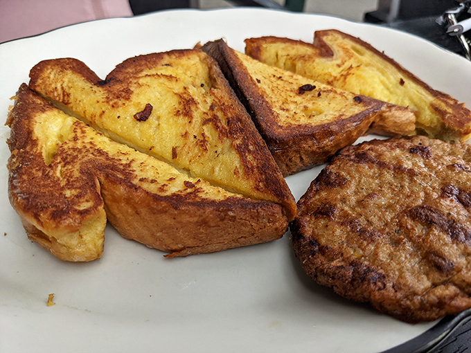 The holy trinity of breakfast: perfectly caramelized French toast, a sausage patty with just the right snap, and zero pretension.