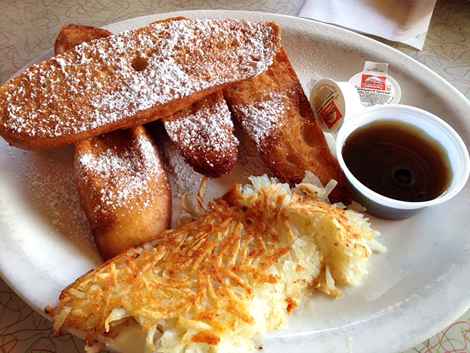 That golden hash brown crown deserves its own ZIP code. Paired with powdered sugar-dusted French toast and syrup, it's breakfast royalty done right.