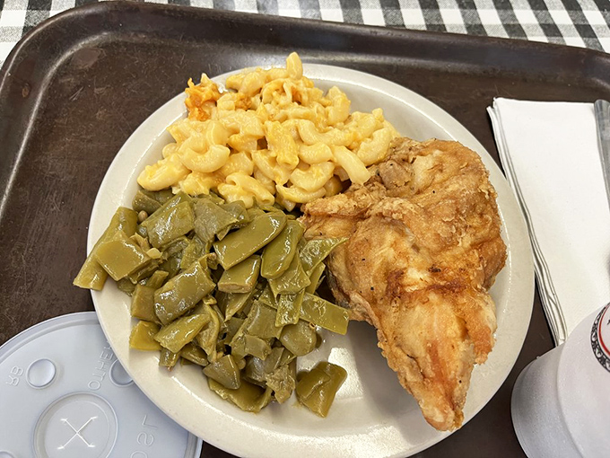 The holy trinity of Southern comfort: golden-fried chicken, mac and cheese that means business, and green beans cooked with conviction.