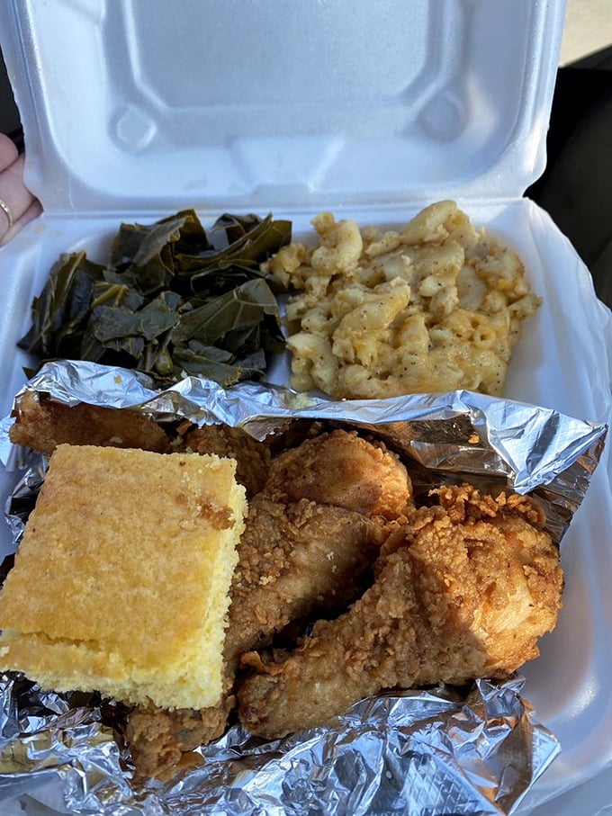 The holy trinity of soul food: perfectly seasoned fried chicken, collard greens cooked with wisdom, and mac and cheese that could end arguments.