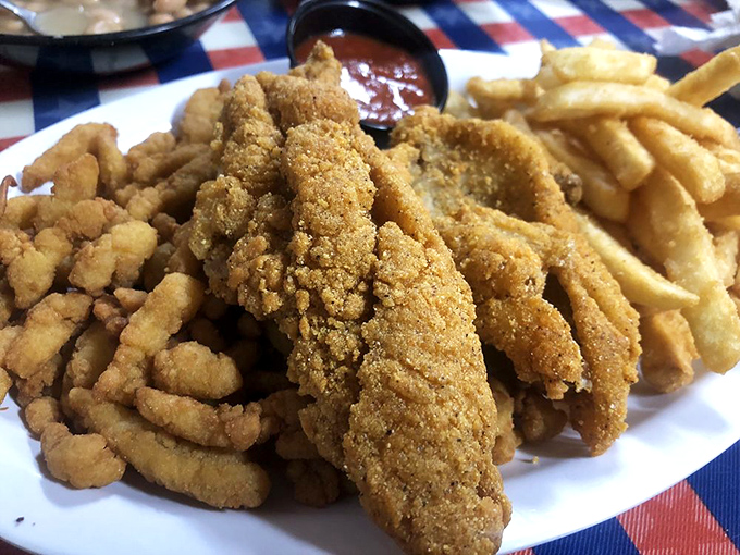 The holy trinity of Southern comfort: golden-fried catfish, crispy clam strips, and French fries&mdash;a plate that makes diets weep and cardiologists buy vacation homes.