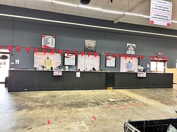 The front desk serves as mission control for this retail adventure. Those price signs hold the secret to timing your visit perfectly.
