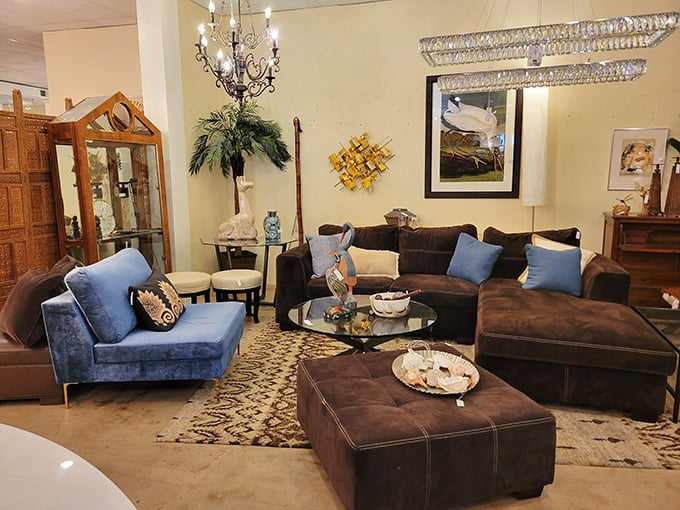Rich chocolate sectionals paired with vibrant blue accents create a living room straight out of Architectural Digest. Comfort meets sophistication in this perfectly staged scene.
