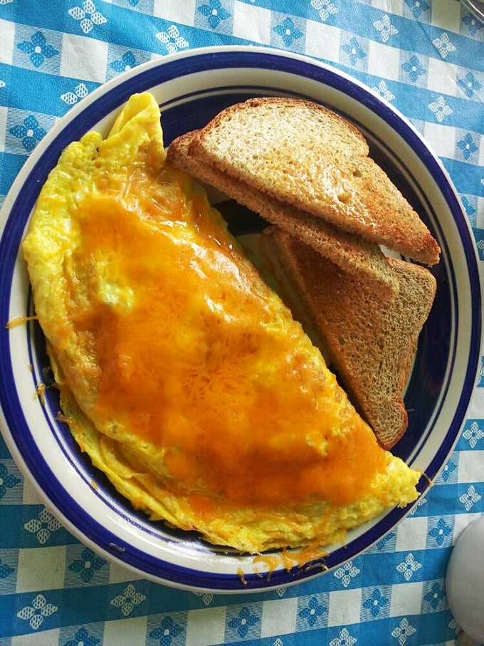 This isn't just any omelet &ndash; it's a cheese-draped morning masterpiece that makes hitting the snooze button seem like a criminal offense.