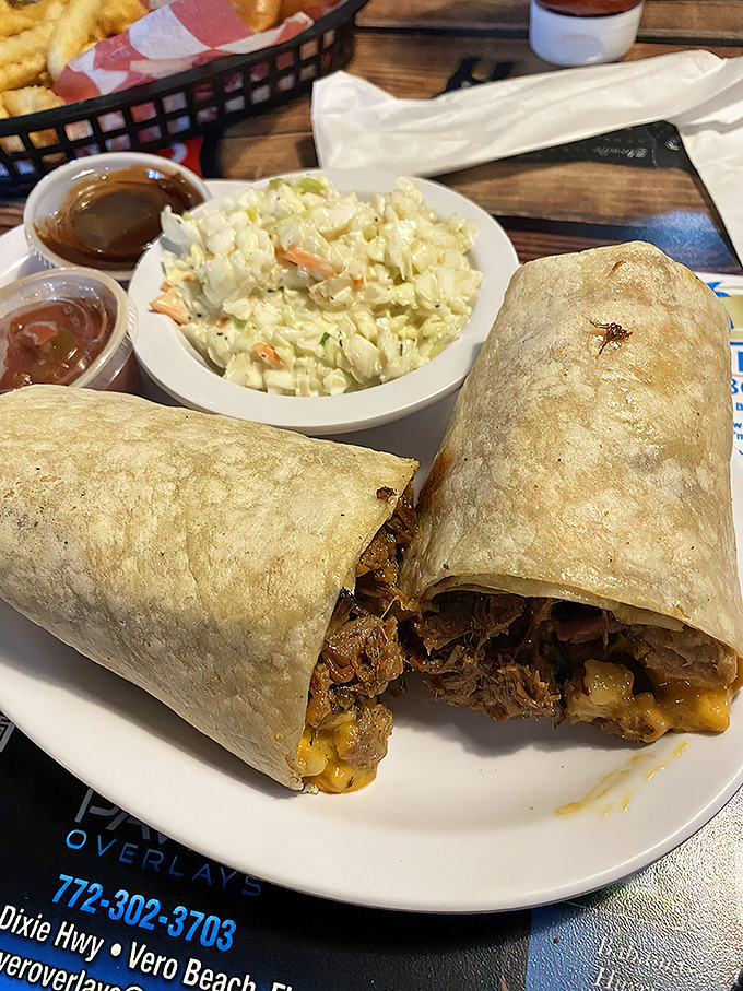 Burritos: nature's most perfect food delivery system. This one's so stuffed it needs its own zip code and comes with a side of creamy coleslaw for balance.