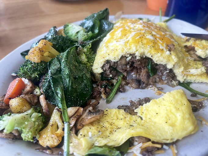 This isn't just an omelet—it's a protein-packed treasure chest. Vegetables nestled inside fluffy eggs like they've found their forever home.