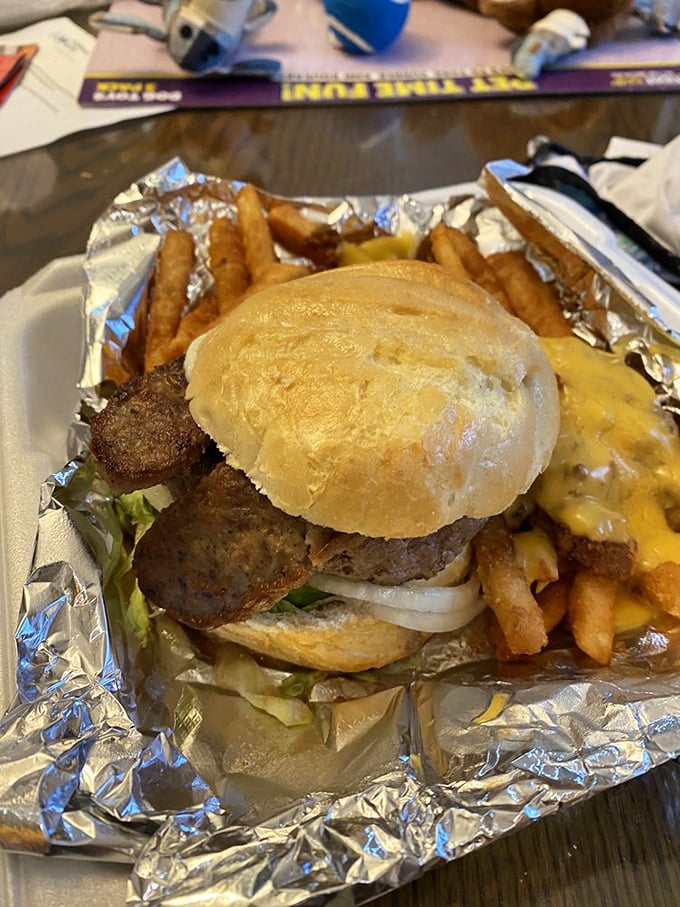 The Gypsy Burger arrives on its aluminum throne, a testament to the fact that sometimes the messiest meals make the most beautiful memories.