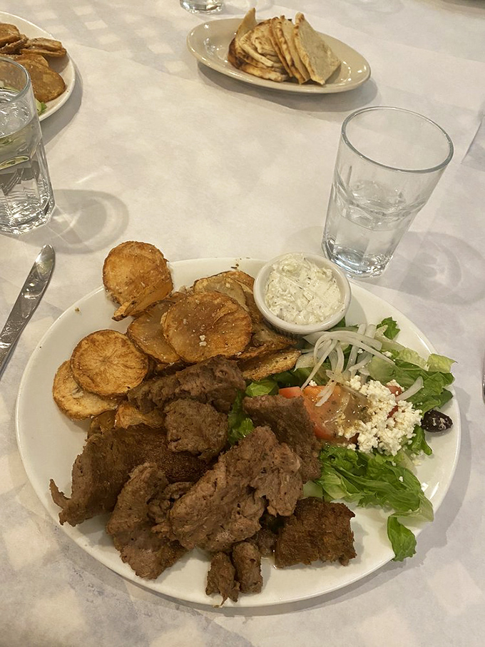 When meat, potatoes, and Greek salad share a plate, it's not just dinner&mdash;it's a Mediterranean committee meeting where everyone gets along.