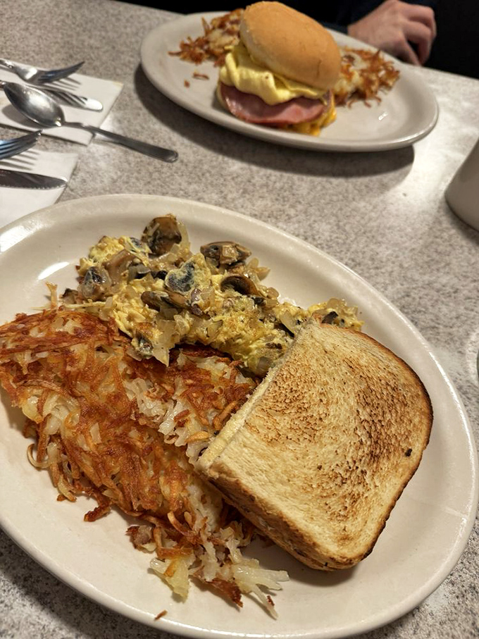 Breakfast perfection on a plate: a mushroom omelet, crispy hash browns, and perfectly toasted bread&mdash;the holy trinity of morning comfort.