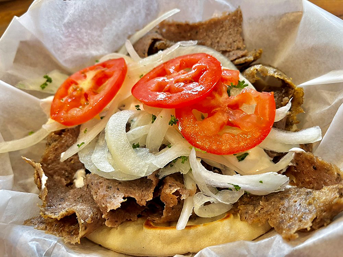 Layer upon layer of thinly sliced gyro meat, fresh tomatoes, and onions&mdash;a sandwich architecture that would make Frank Lloyd Wright weep with joy.