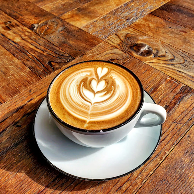 The wooden table tells stories while your latte whispers sweet nothings &ndash; a moment of caffeinated perfection worth savoring slowly.