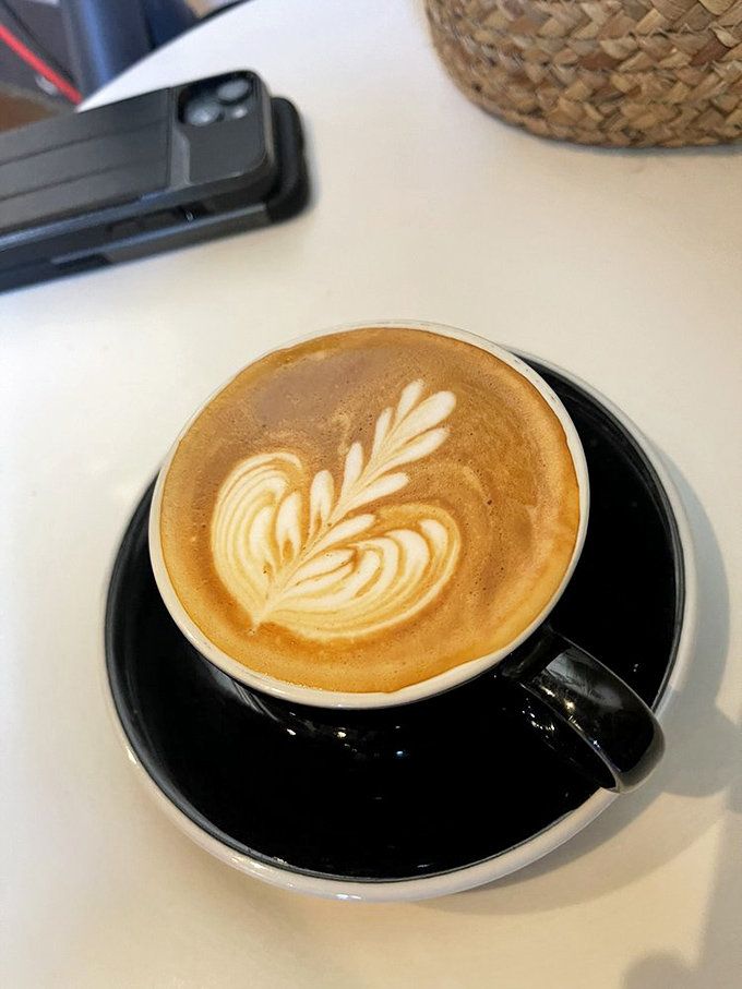 The barista's canvas&mdash;where milk and espresso perform a delicate dance. This latte art leaf pattern proves coffee-making is as much artistry as science.