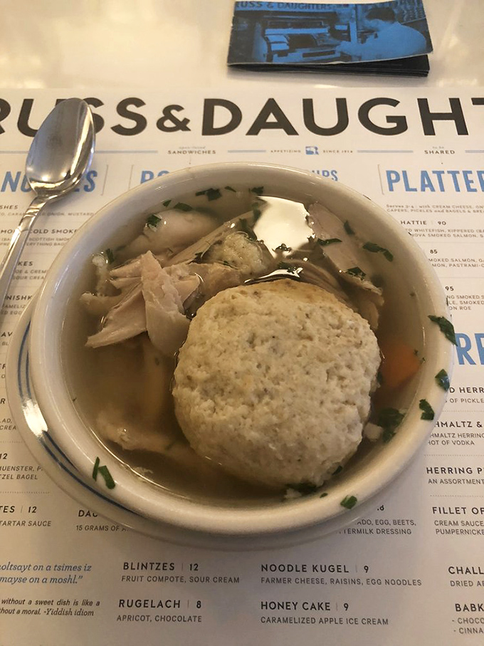 A matzo ball so perfectly balanced it practically defies gravity, floating in broth that took someone's grandmother hours to perfect.