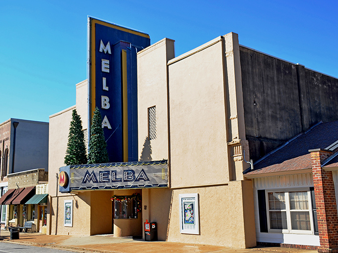 The Melba Theatre's neon marquee glows like a beacon from another era, promising movie magic in a setting that's a star in its own right.
