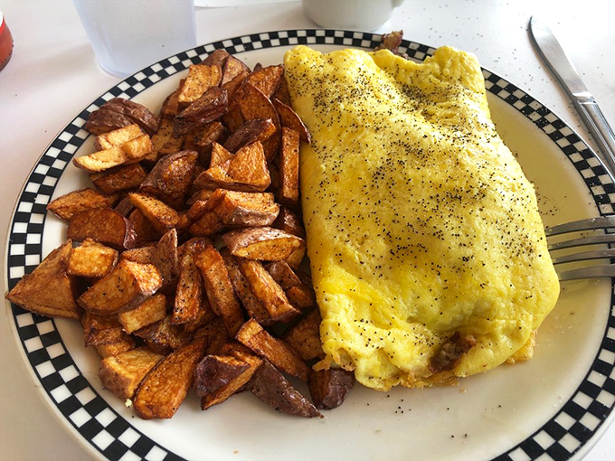 This omelet doesn't just feed you&mdash;it embraces you. Those home fries look like they've been practicing their crispy-on-the-outside, fluffy-inside routine for decades.