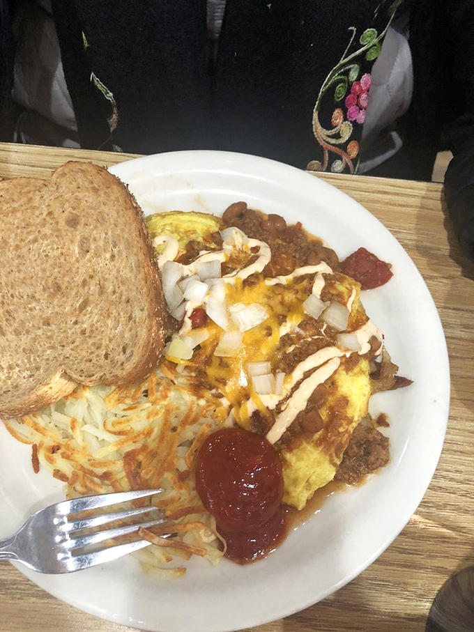 This isn't just breakfast—it's edible architecture. Layers of flavor crowned with those legendary hash browns that justify the drive to Boulder City.