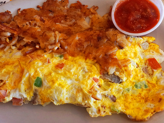 This omelet doesn't just come with hash browns&mdash;it arrives with a golden-brown crown of potato perfection that deserves its own zip code.