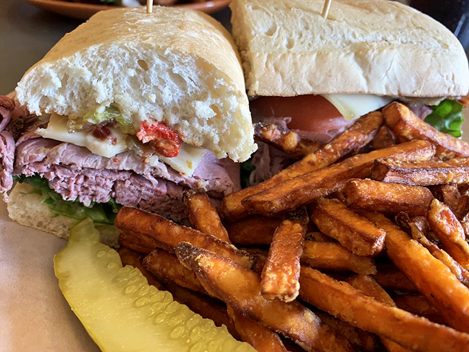 The hero we deserve &ndash; tender pastrami nestled in fresh bread with crispy sweet potato fries standing guard. This sandwich doesn't need a cape to save your day.