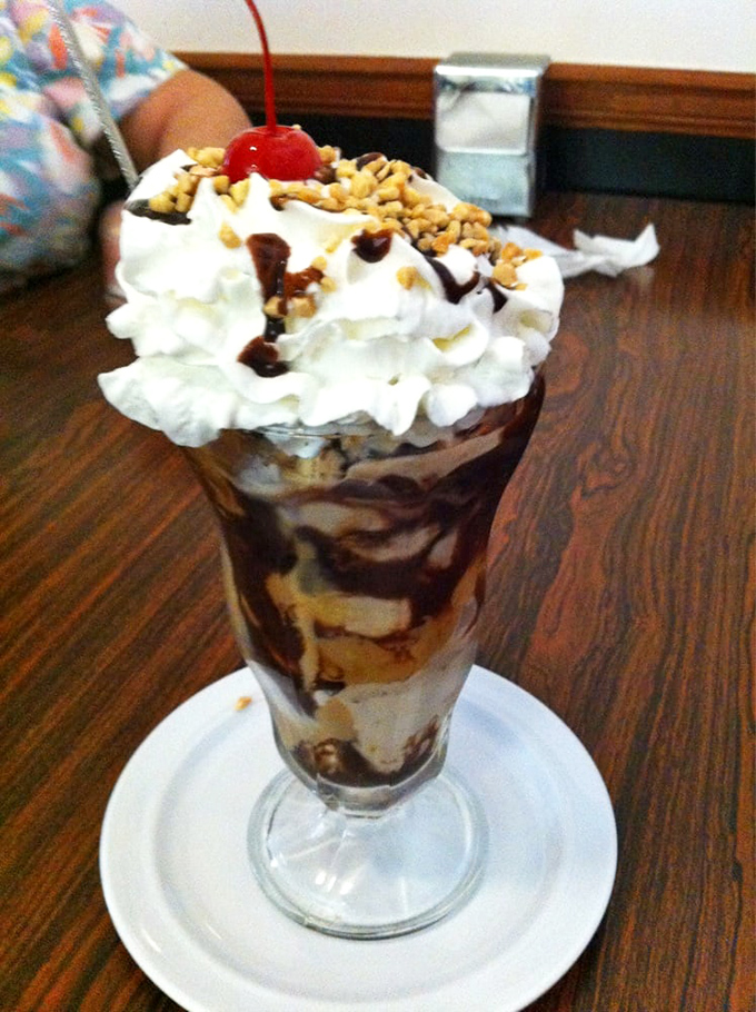 Layers of possibility unfold in this parfait glass—chocolate and peanut butter performing their timeless duet under a cloud of whipped cream.