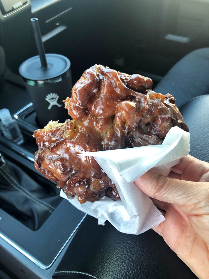 Car dashboard dining at its finest. This apple fritter isn't just a donut; it's the reason people set alarms and drive across county lines.