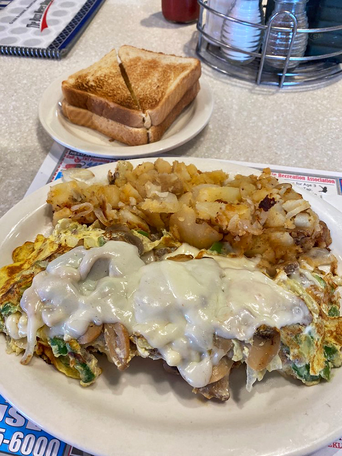 This isn't just breakfast, it's an event. The Philly steak omelette arrives draped in gravy with a supporting cast of crispy potatoes and toast soldiers.