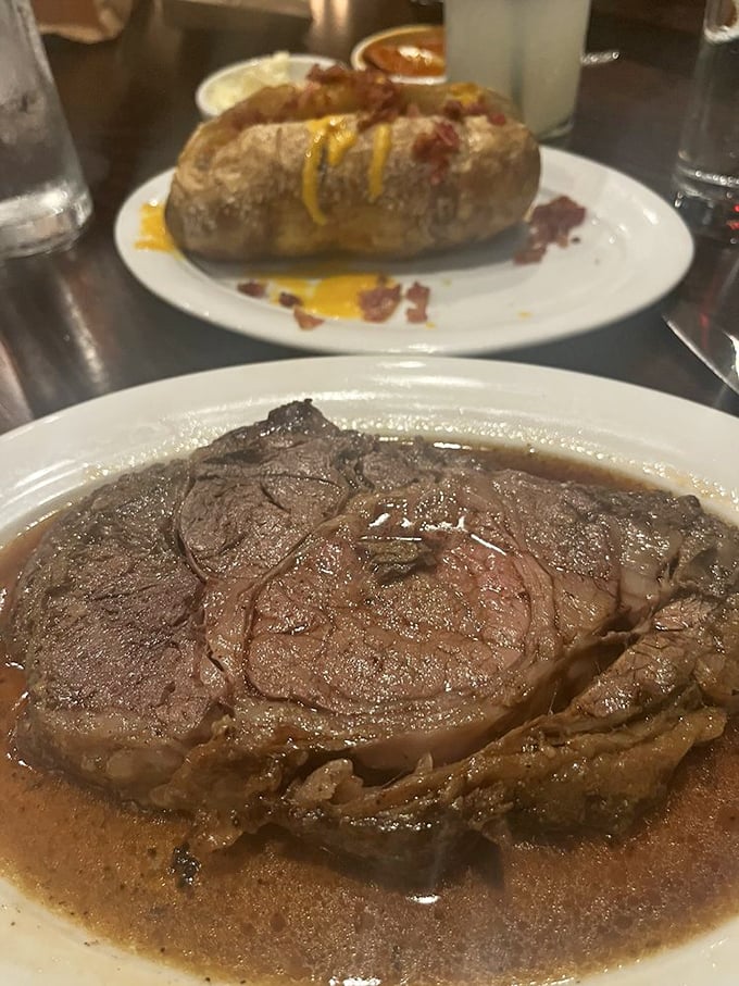 The juicy prime rib steals the spotlight while a loaded baked potato plays the delicious sidekick, wearing cheese and bacon like edible jewelry.